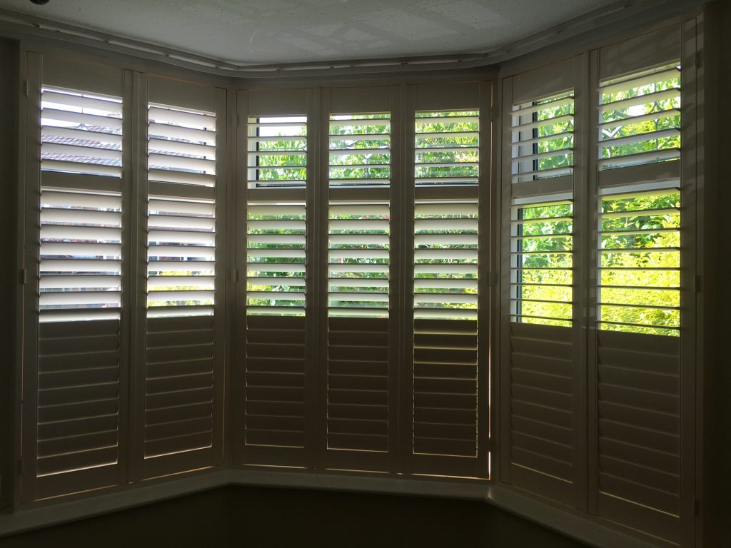 Before & after images of this bay window shutter install in Stockport - Absolute